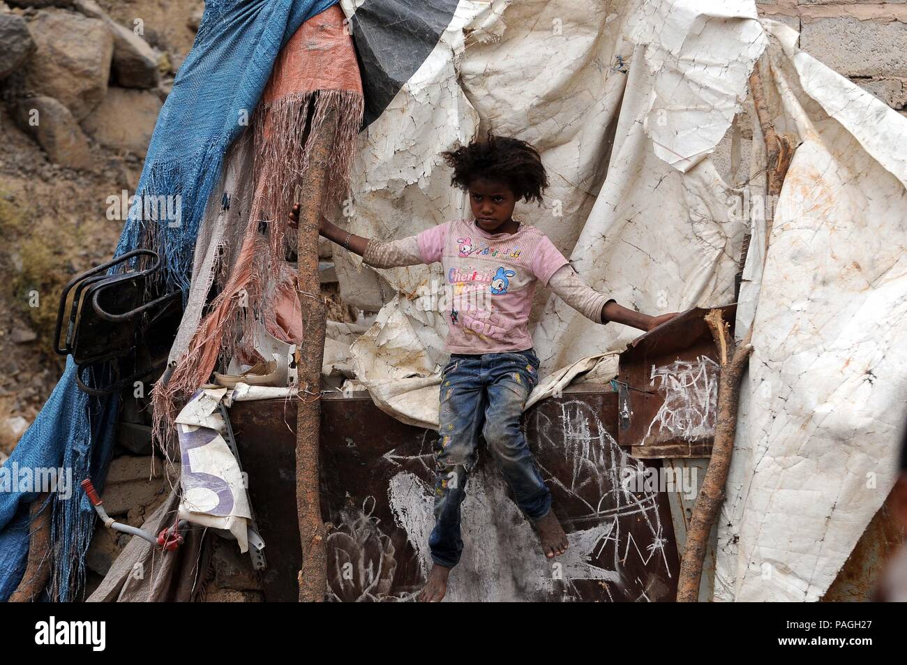 Sanaa, Yemen. 22nd July, 2018. A displaced girl sits in front of a tent ...