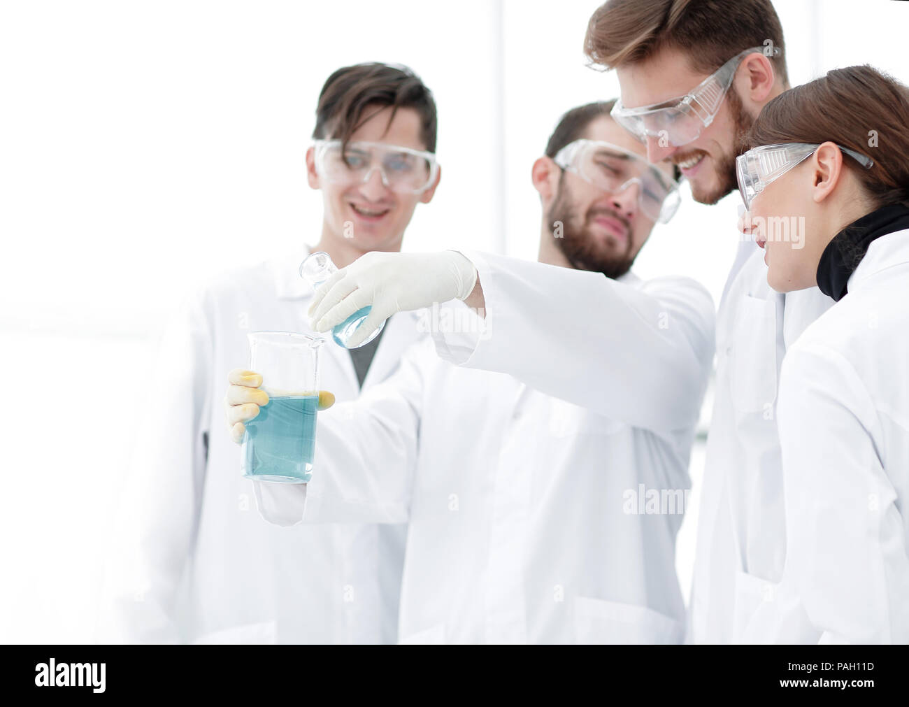 group of scientists working with chemicals Stock Photo - Alamy