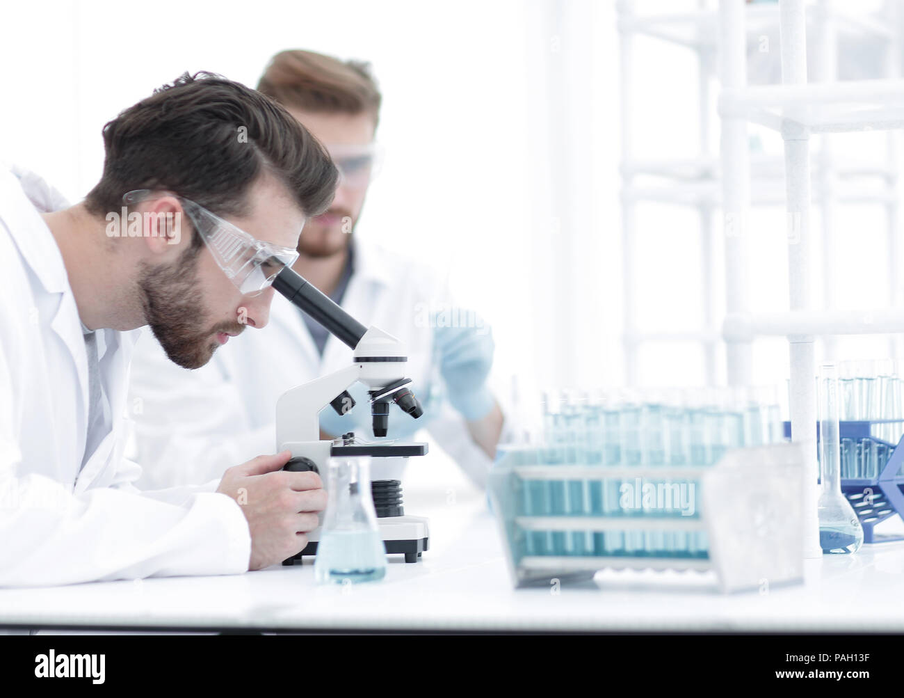 biologist explores the substance under the microscope Stock Photo - Alamy