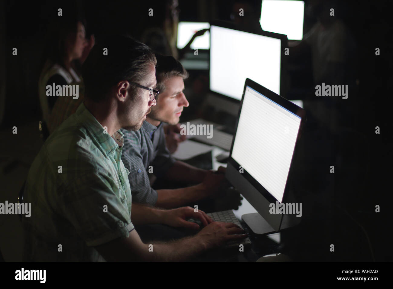 business team works on computers at night Stock Photo - Alamy