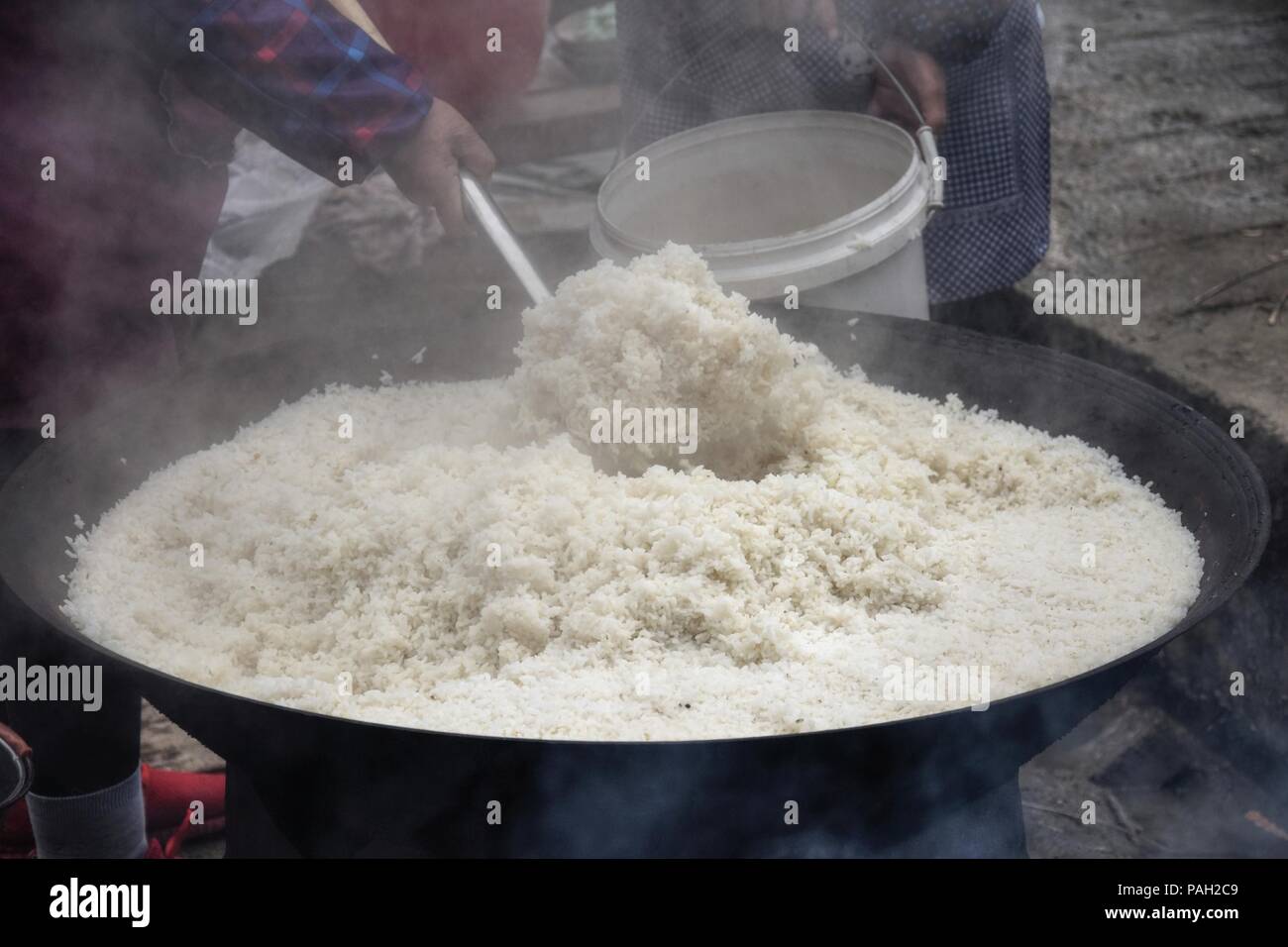 Cooking the rice on a large scale. Outdoor kitchen Stock Photo - Alamy