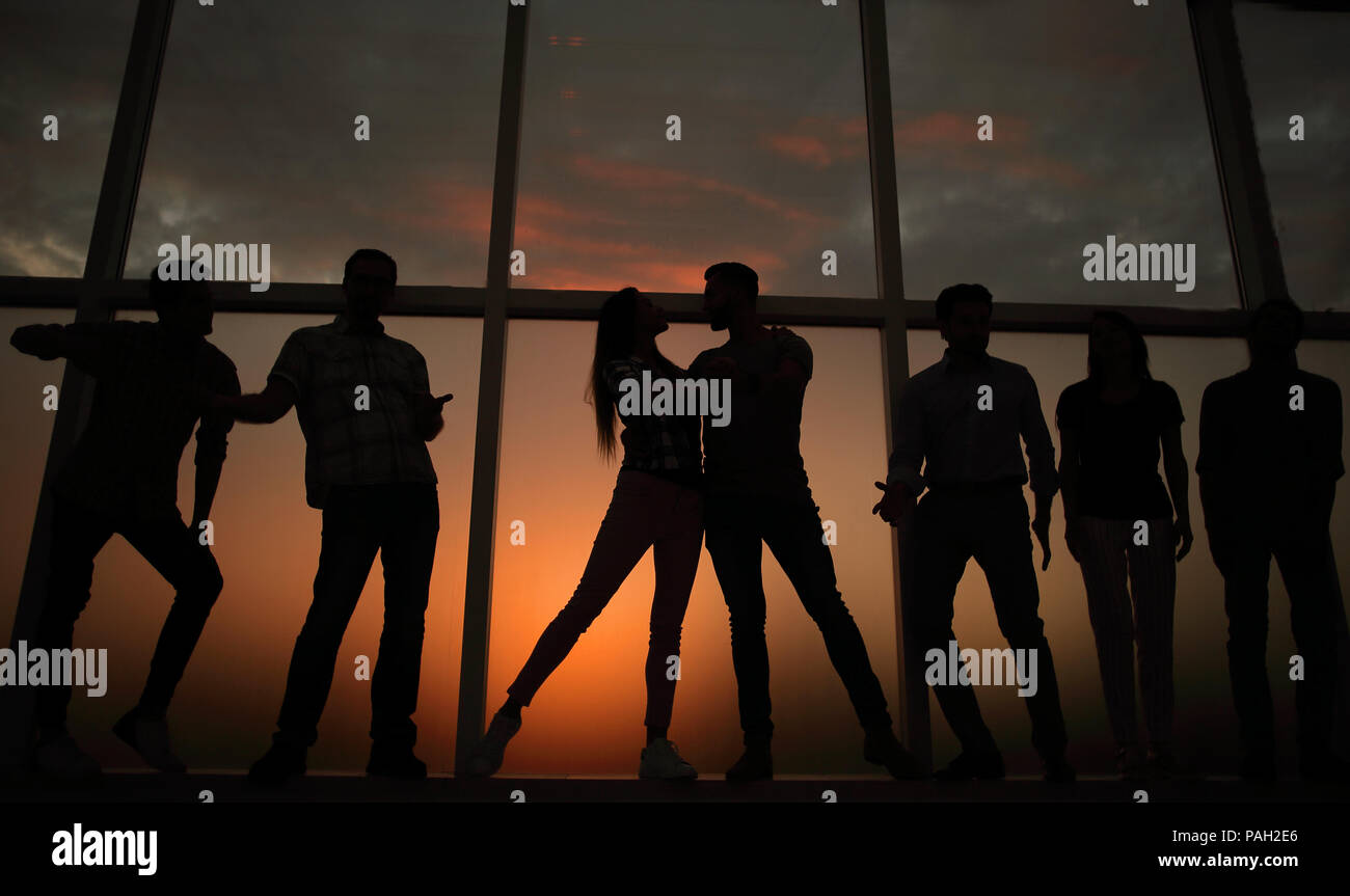 modern young people on the background of a large window Stock Photo - Alamy