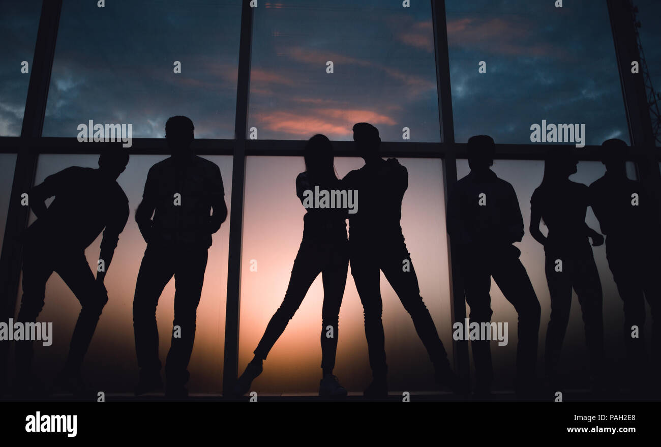 group of young people in the background of a large window Stock Photo ...