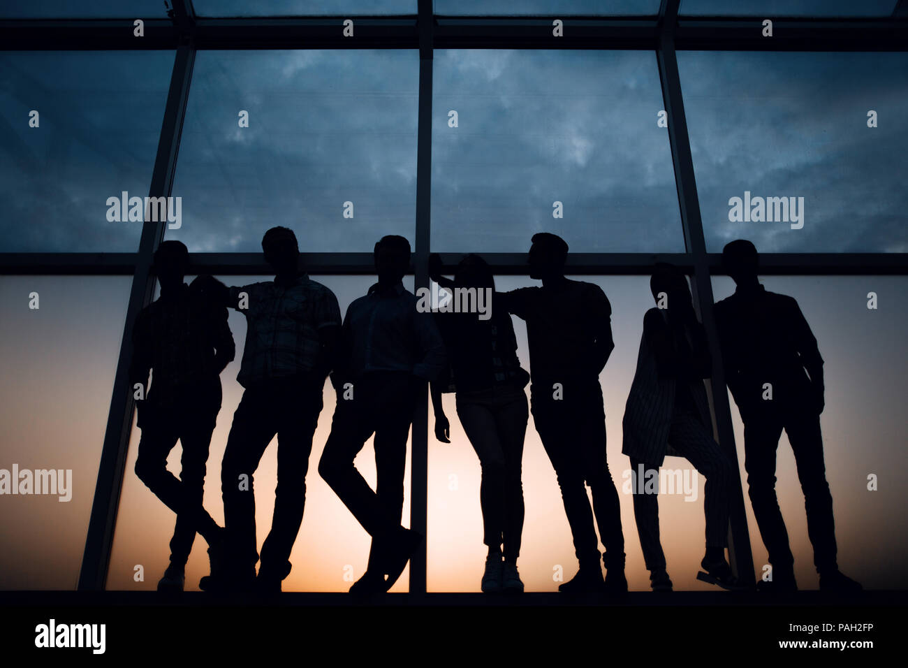 creative business team standing near the office window Stock Photo - Alamy