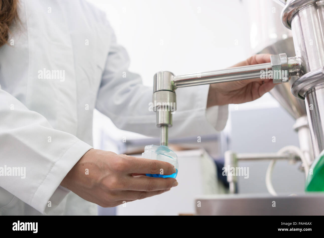 Technician filling container with liquid for laboratory tests Stock ...