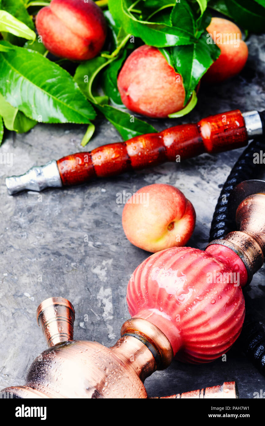 Hookah for smoking with the aroma peach.Peach shisha Stock Photo - Alamy