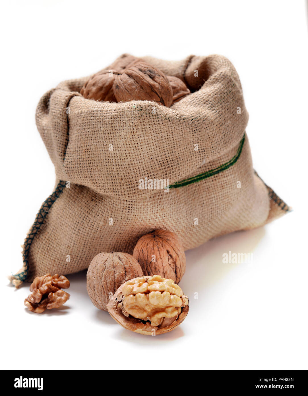 Walnuts and a bag on white Stock Photo - Alamy