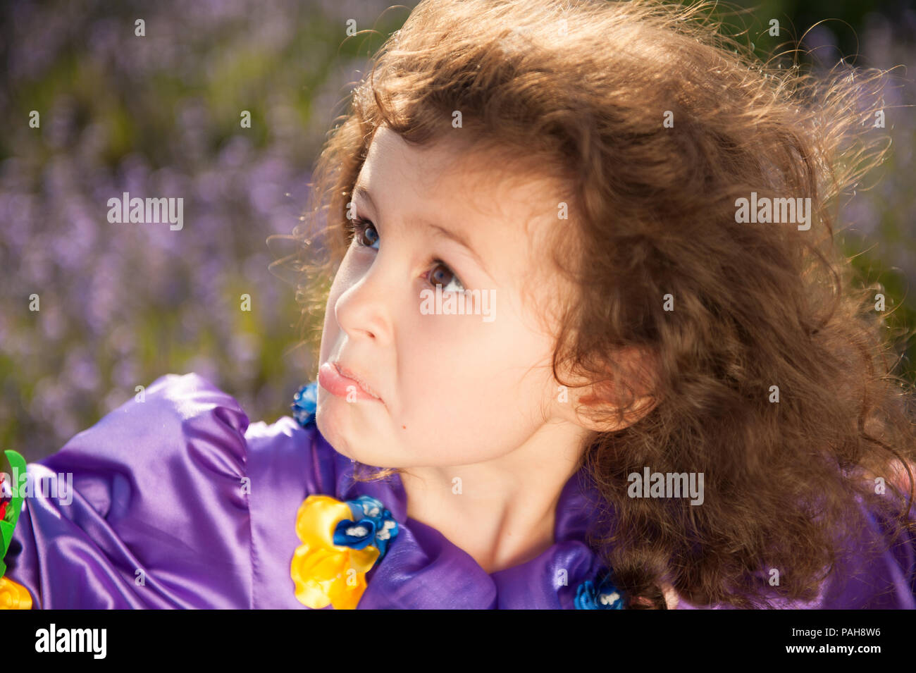 funny face grimace of cute small girl with curly hair outdoors Stock ...