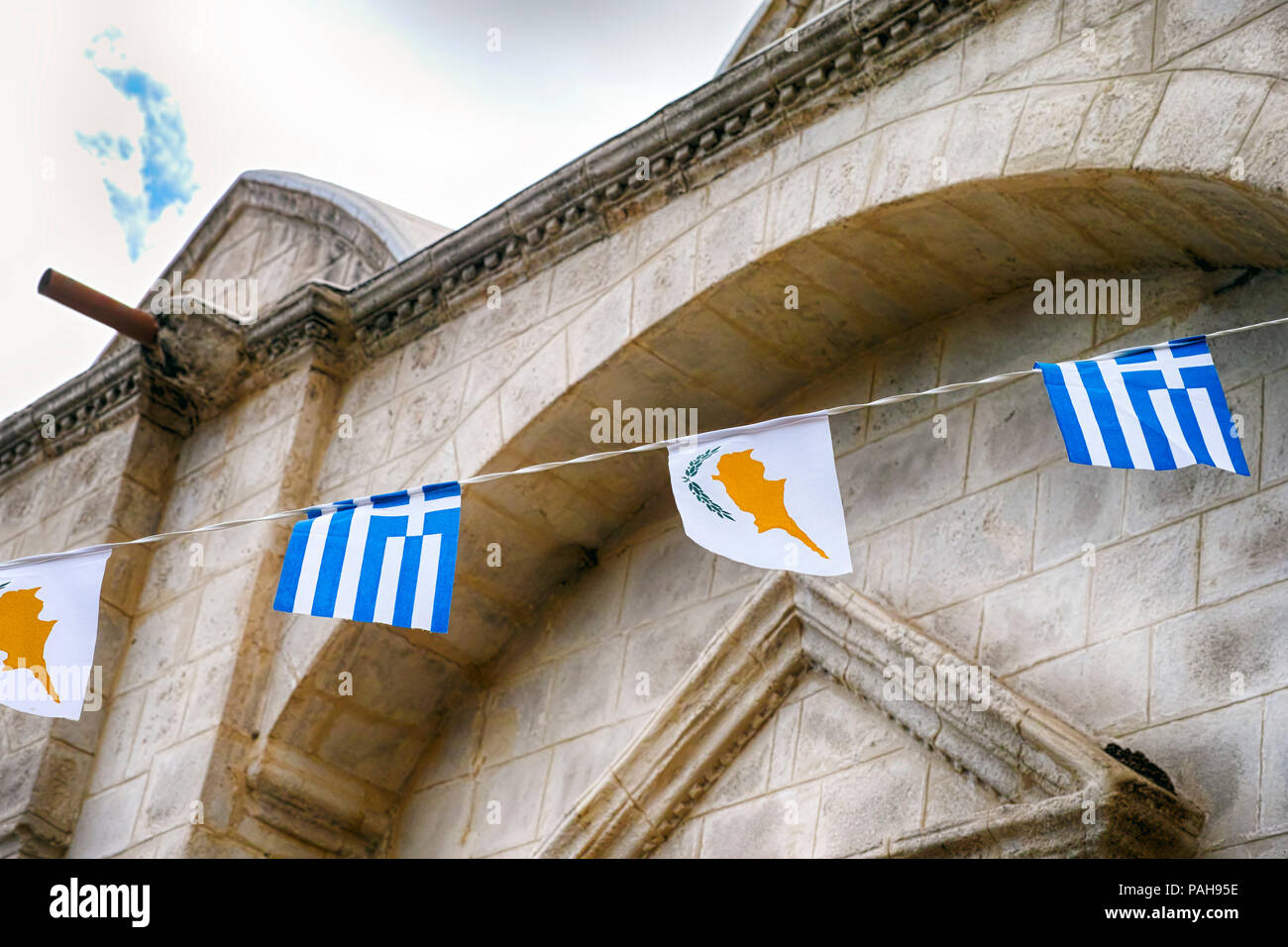 Cyprus and Greek flags on the rope against old stone building Stock ...