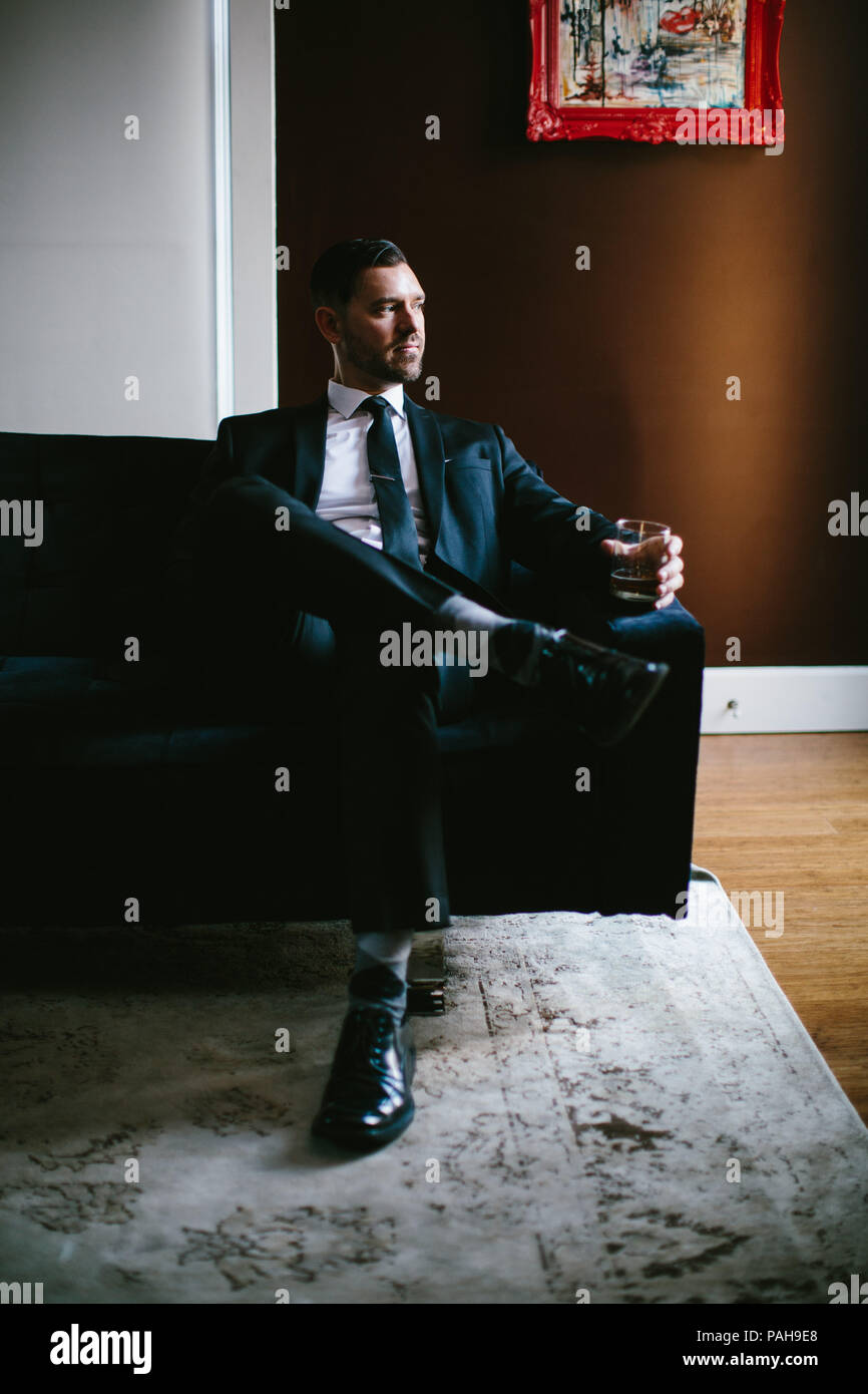 professional man looking off into the distance with a drink Stock Photo ...