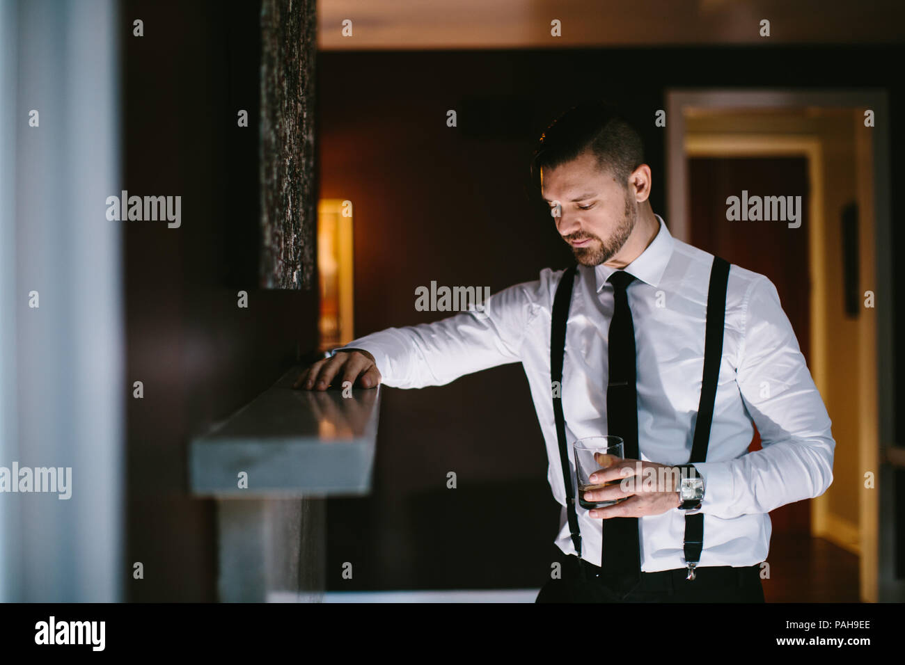 professional man looking down pensively Stock Photo - Alamy