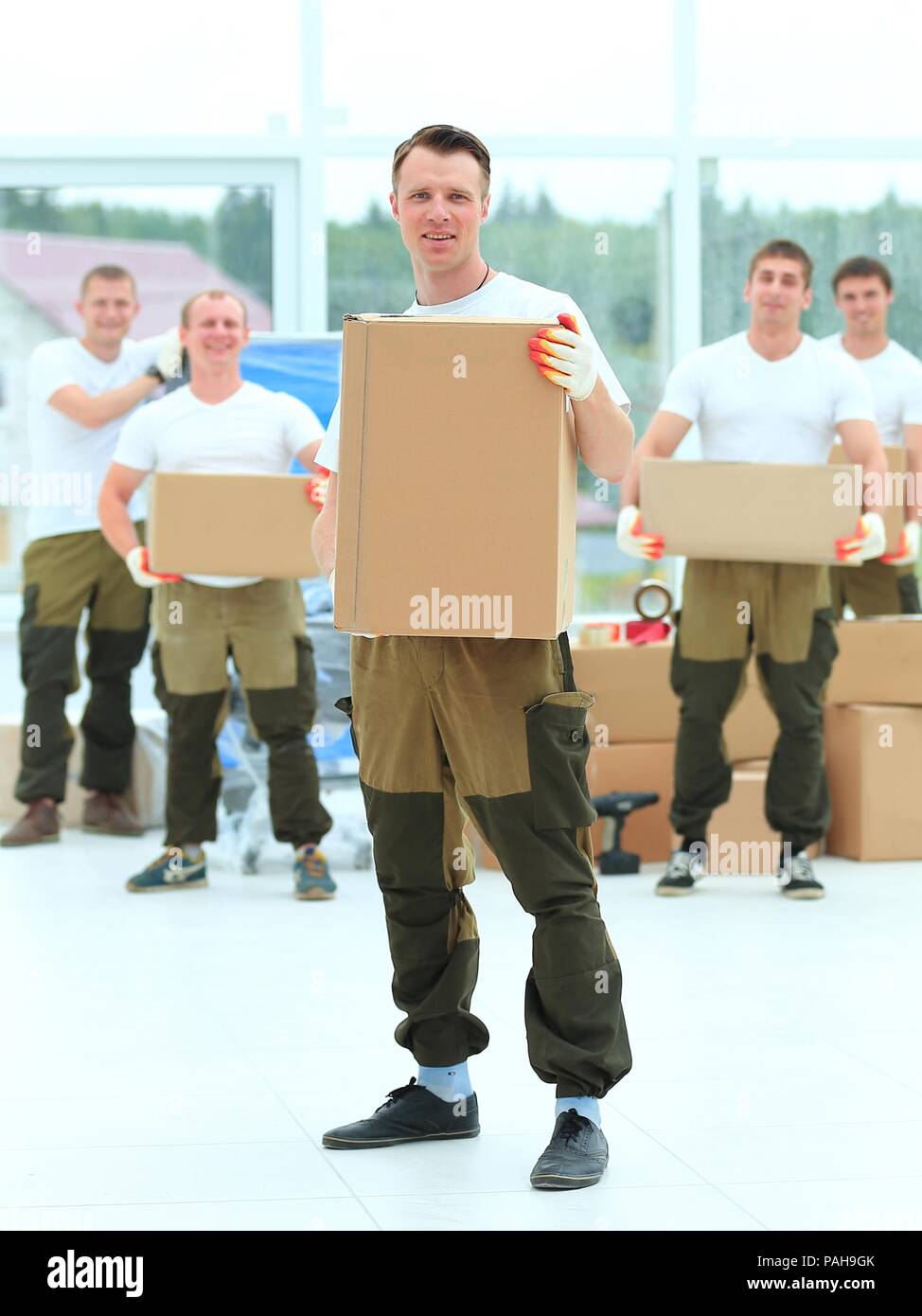 foreman and workers with boxes of building materials Stock Photo - Alamy