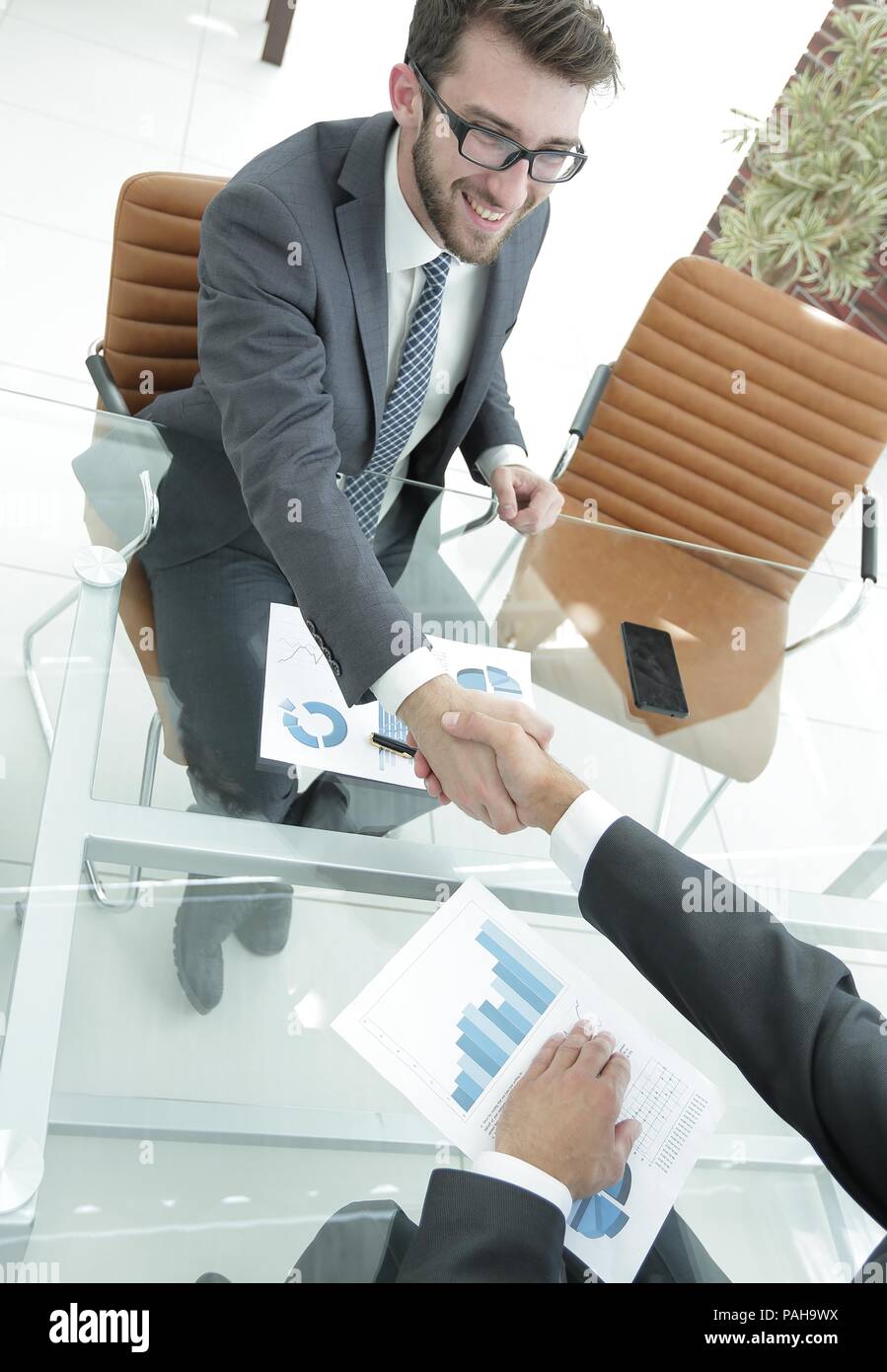handshake business partners at your Desk Stock Photo - Alamy