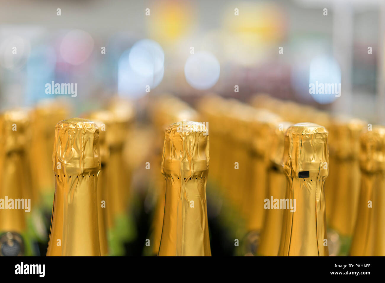 perspective view detail of golden champagne bottles tops arranged in ...