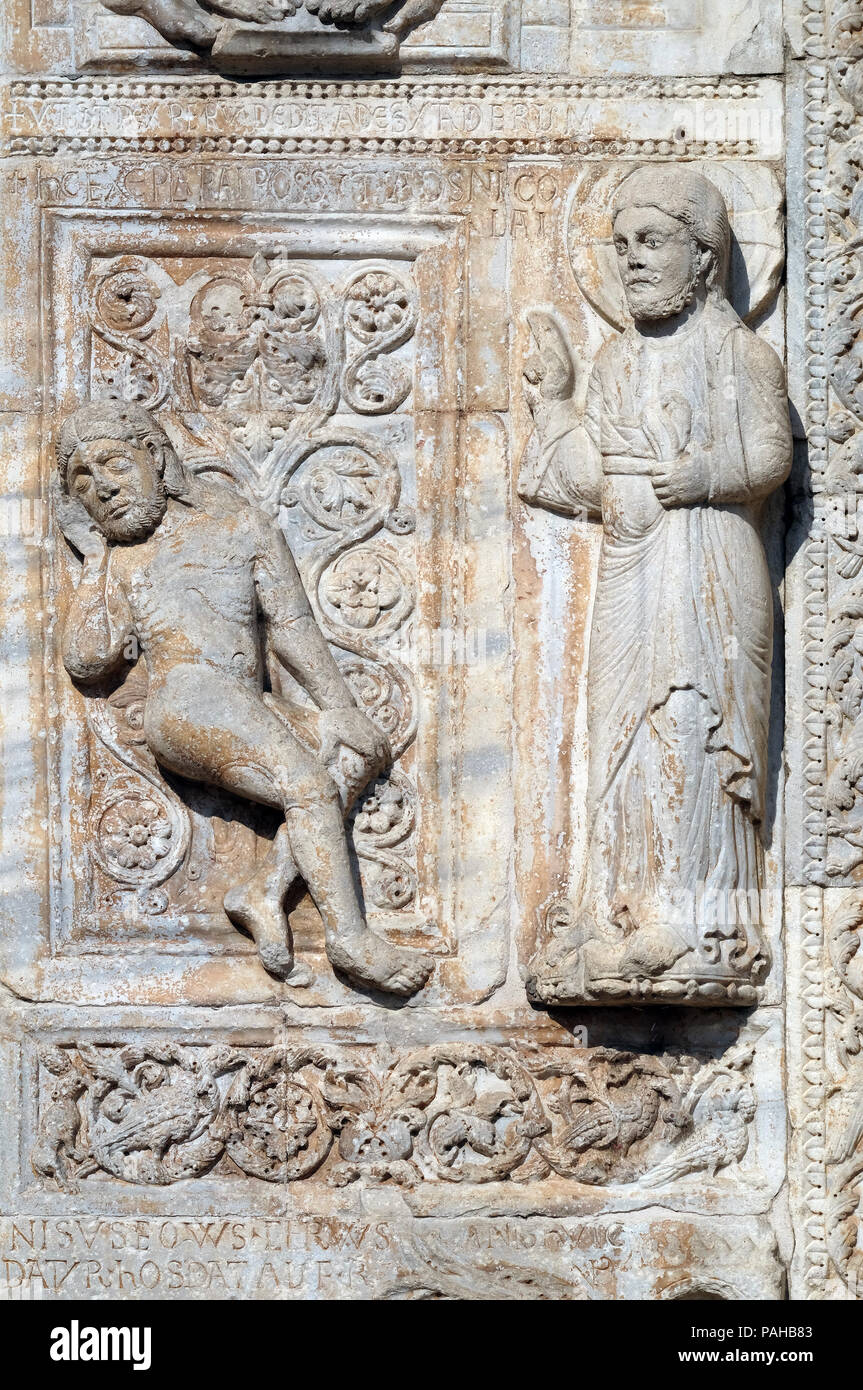Creation of Adam, medieval relief on the facade of Basilica of San Zeno ...