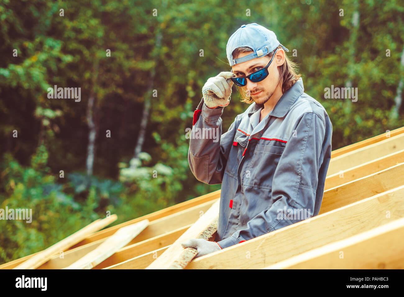worker roofer builder working on roof structure on construction site ...