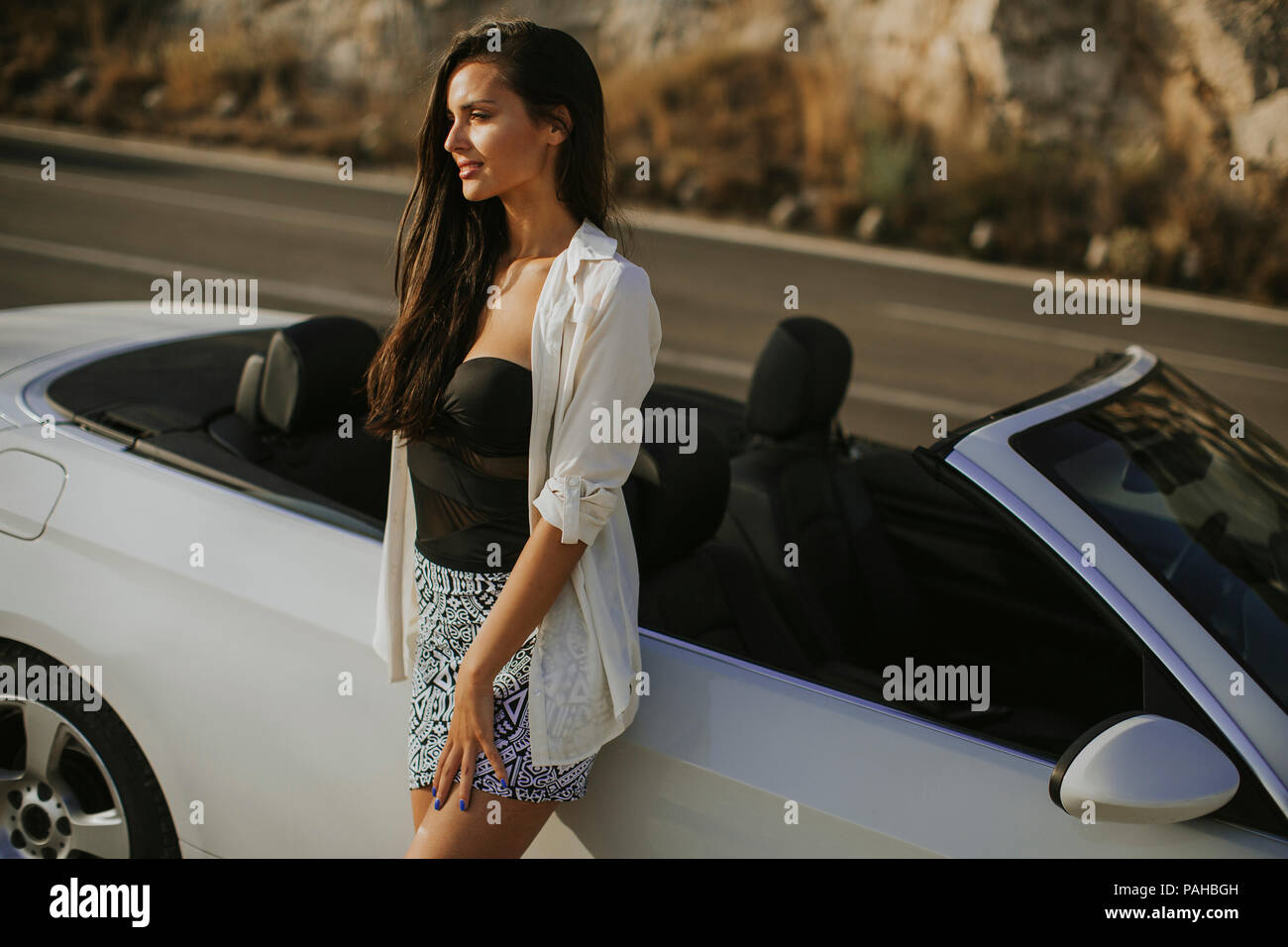 Woman standing by a white car hi-res stock photography and images - Alamy
