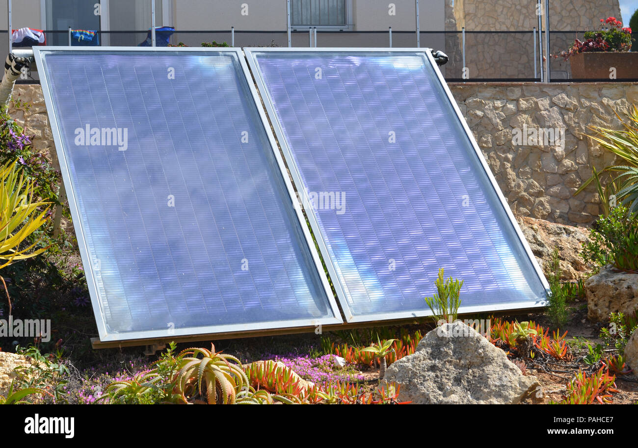 Domestic solar panels in a garden Stock Photo - Alamy