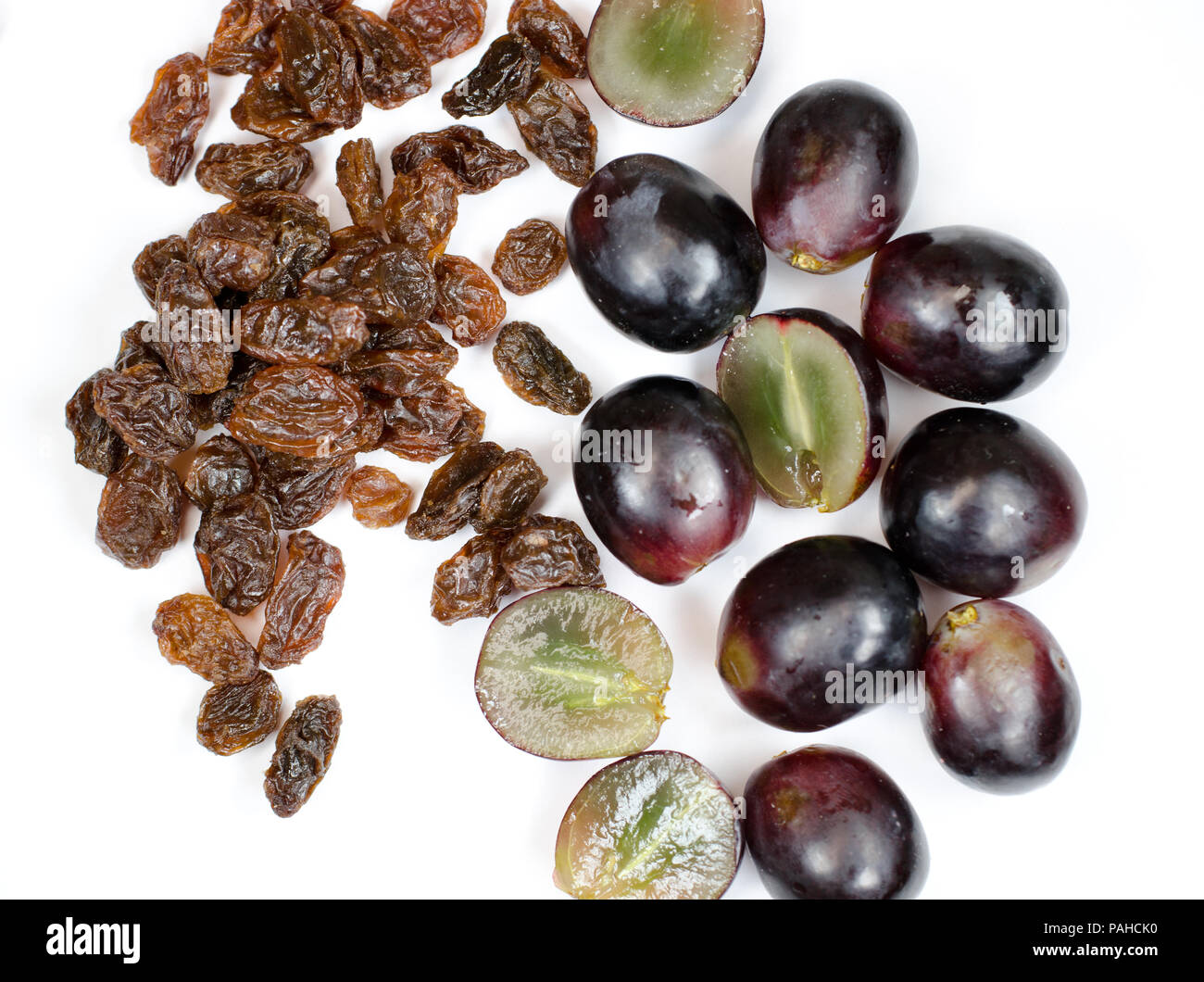 Raisins and grapes on white background Stock Photo - Alamy