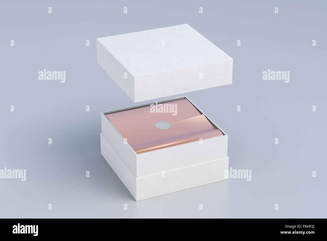 Opened white square box with copper wrapping paper inside box and cover ...