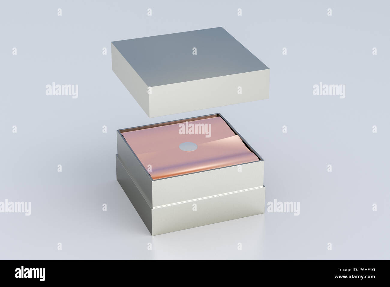 Opened silver square box with copper wrapping paper inside box and ...