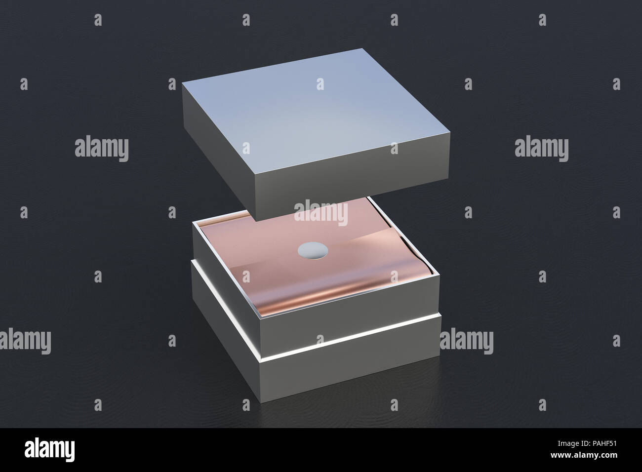 Opened silver square box with copper wrapping paper inside box and ...