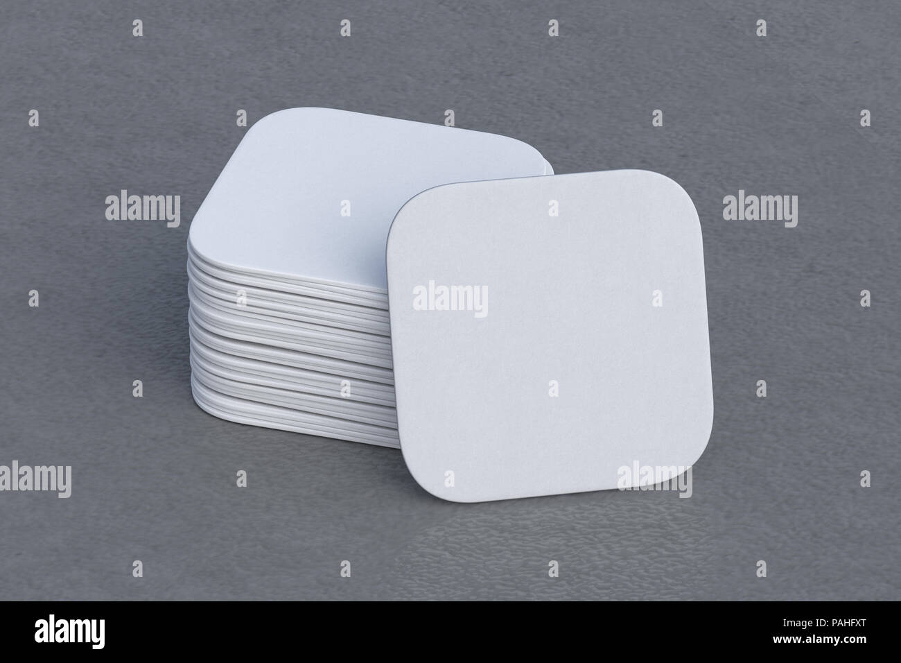 White square beer coasters on gray background with clipping path around ...