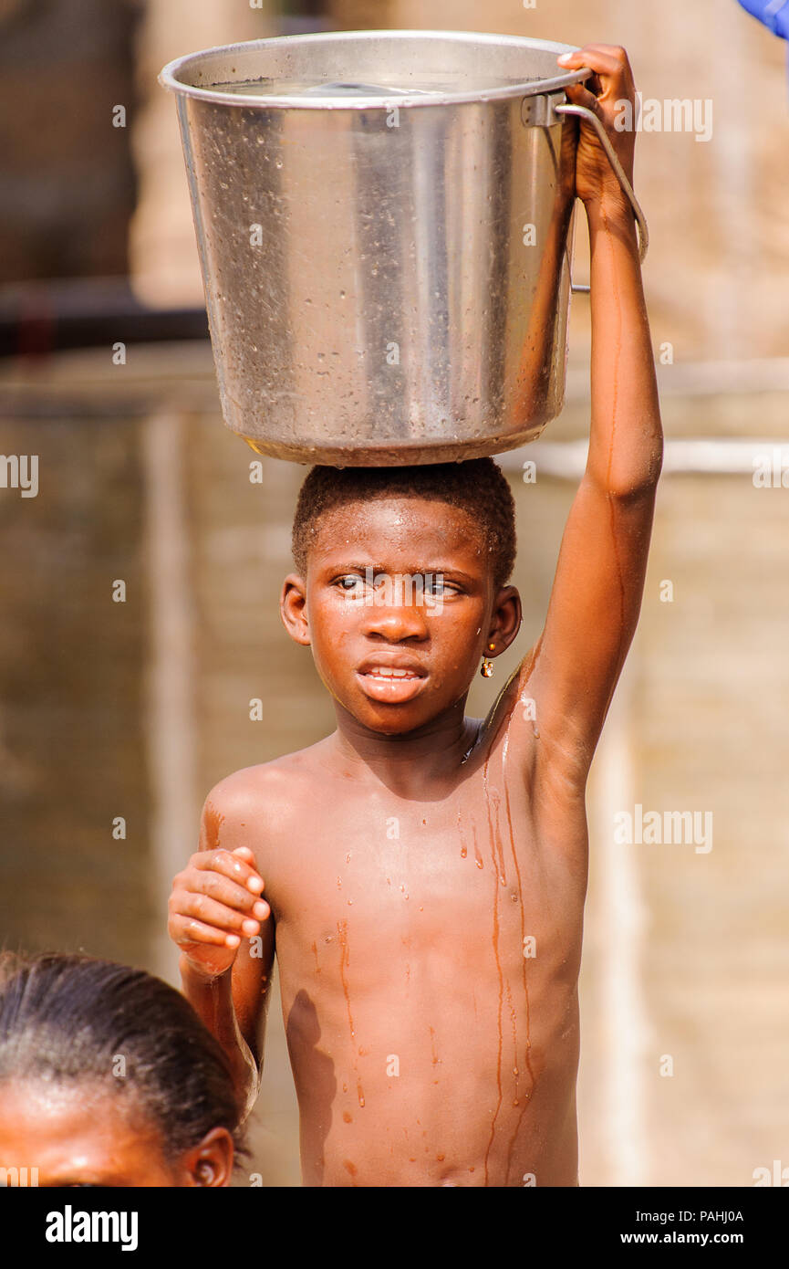 ACCRA, GHANA - MARCH 2, 2012: Unidentified Ghanaian boy with a bucket ...