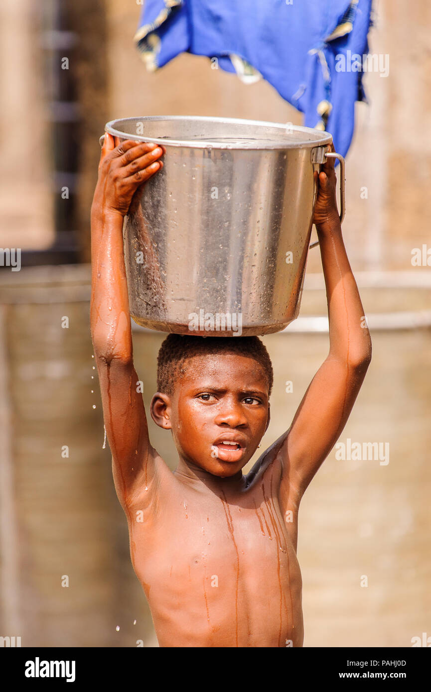 ACCRA, GHANA - MARCH 2, 2012: Unidentified Ghanaian boy with a bucket ...