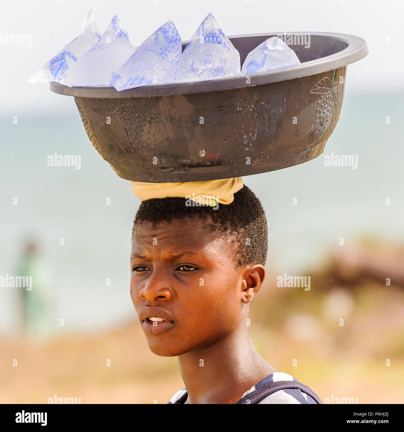 ACCRA, GHANA - MARCH 2, 2012: Unidentified Ghanaian girl sells cold ...