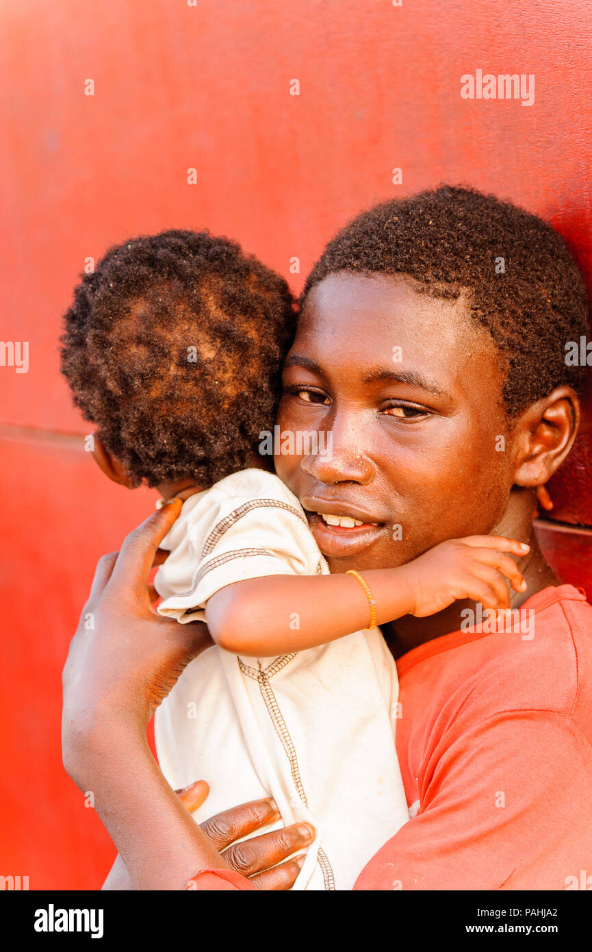 ACCRA, GHANA - MARCH 2, 2012: Unidentified Ghanaian father hugs his ...