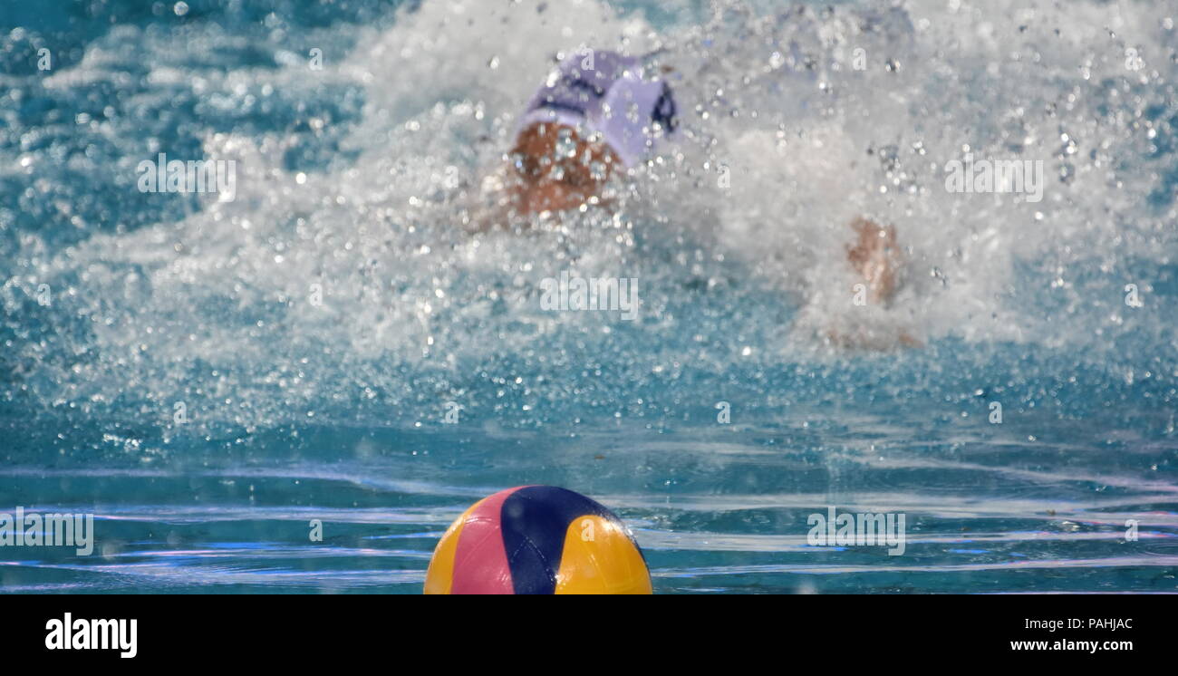 Waterpolo player swimming with the ball Stock Photo - Alamy