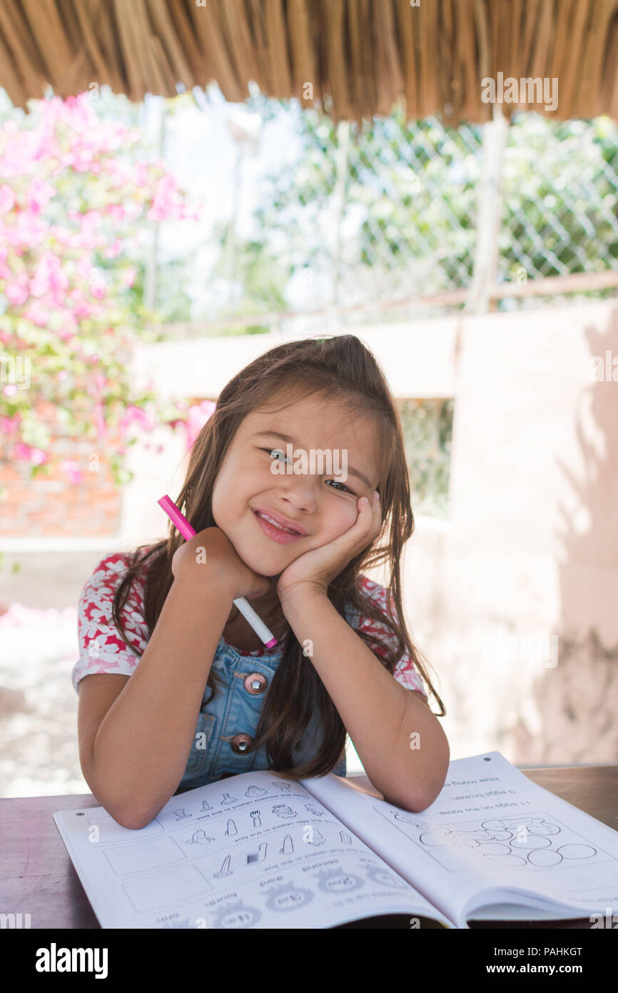 little girl learn book with mathematicks, she is lost in thought and ...