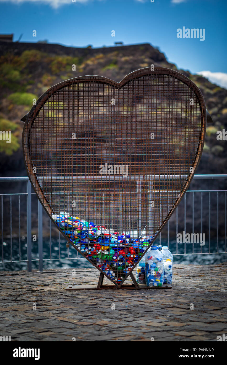 Conceptual garbage can heart-shaped for plastic nuts. Education in ...