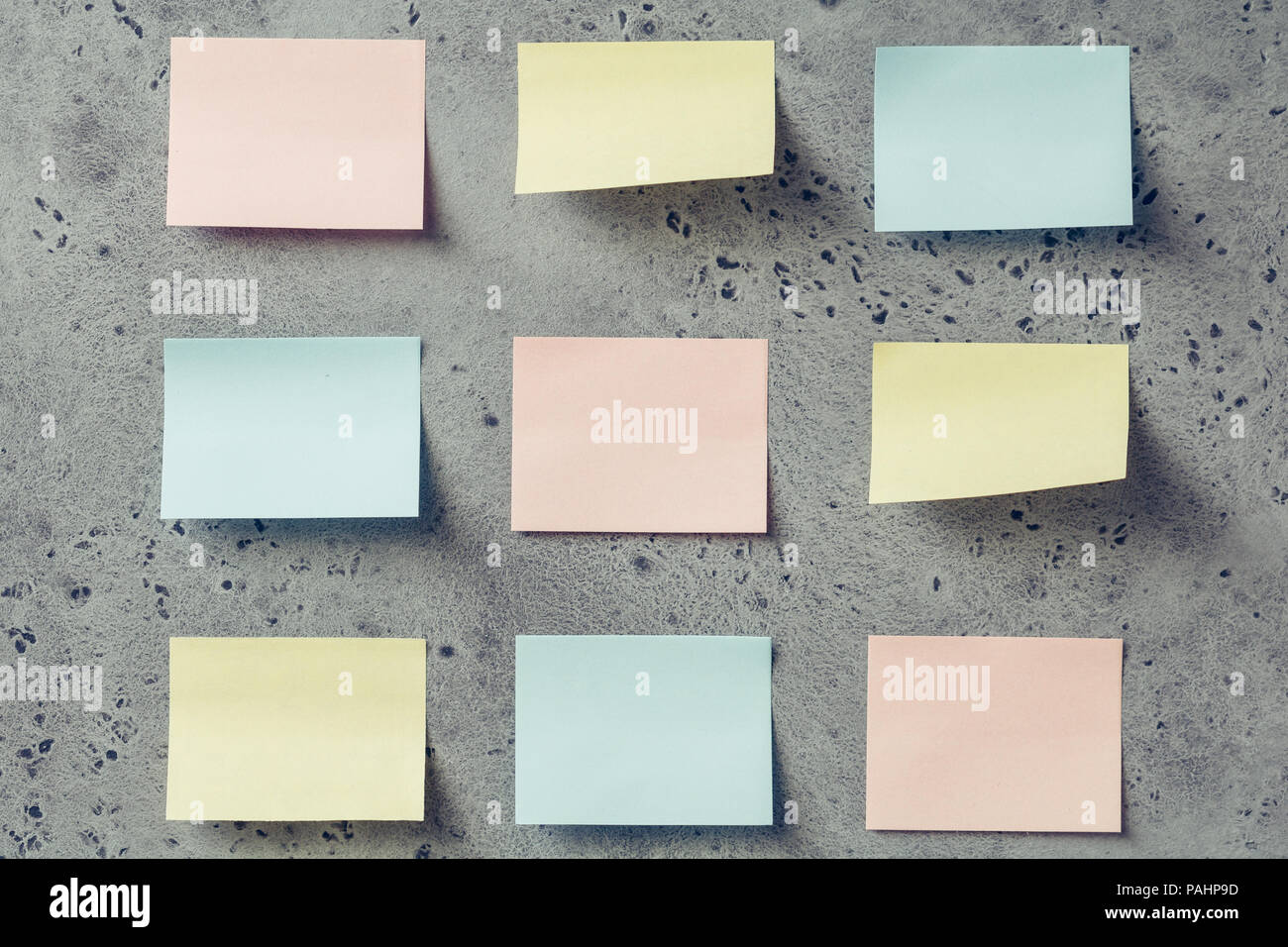 Colorful empty sticky notes on a textured background. The concept ...