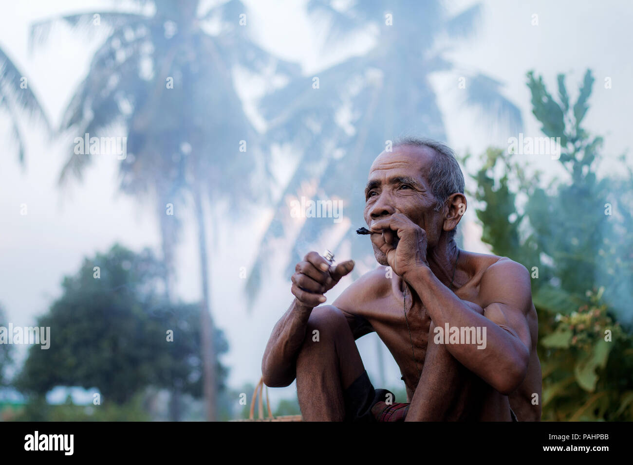 Old man are smoking in the countryside on field Stock Photo - Alamy