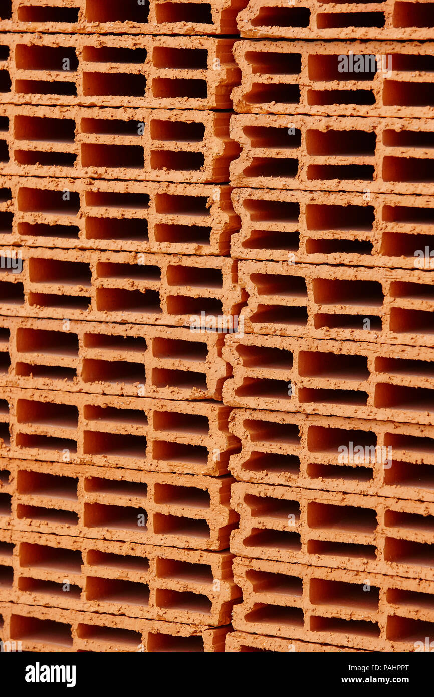 Stacked orange bricks. Construction industry. Building pieces. Vertical ...