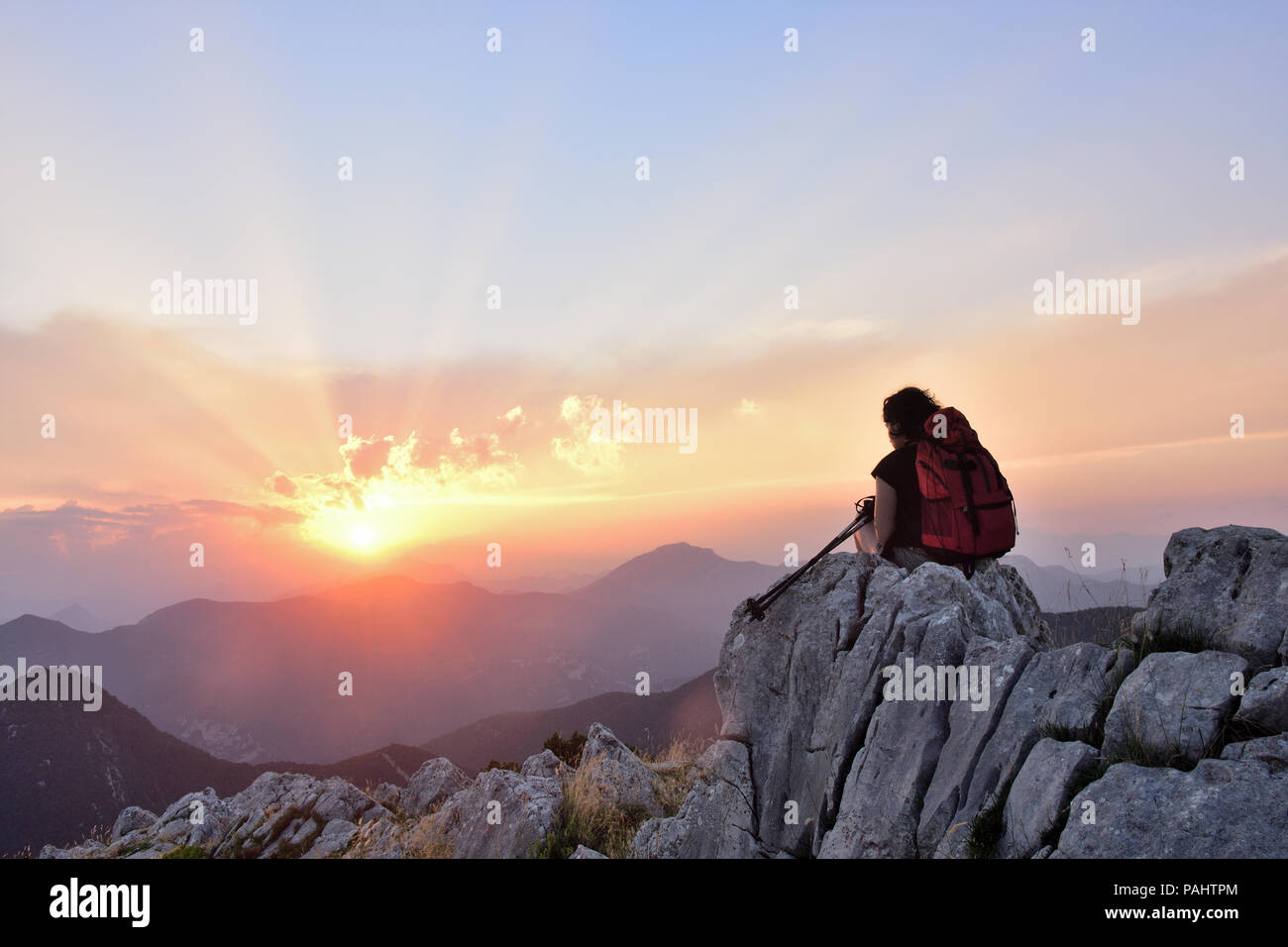 female hiker resting and watching the sunset Stock Photo - Alamy