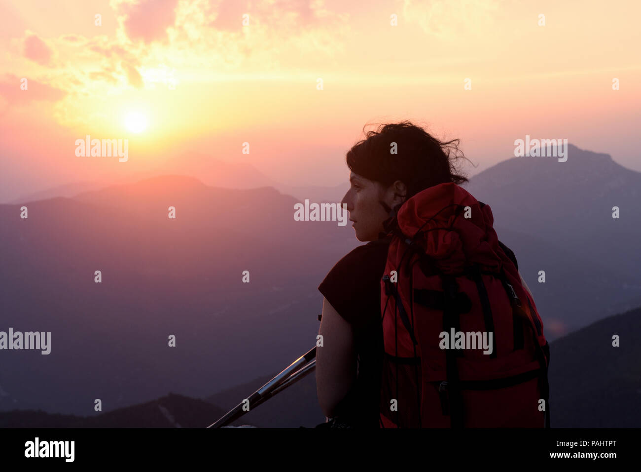 female hiker resting and watching the sunset Stock Photo - Alamy