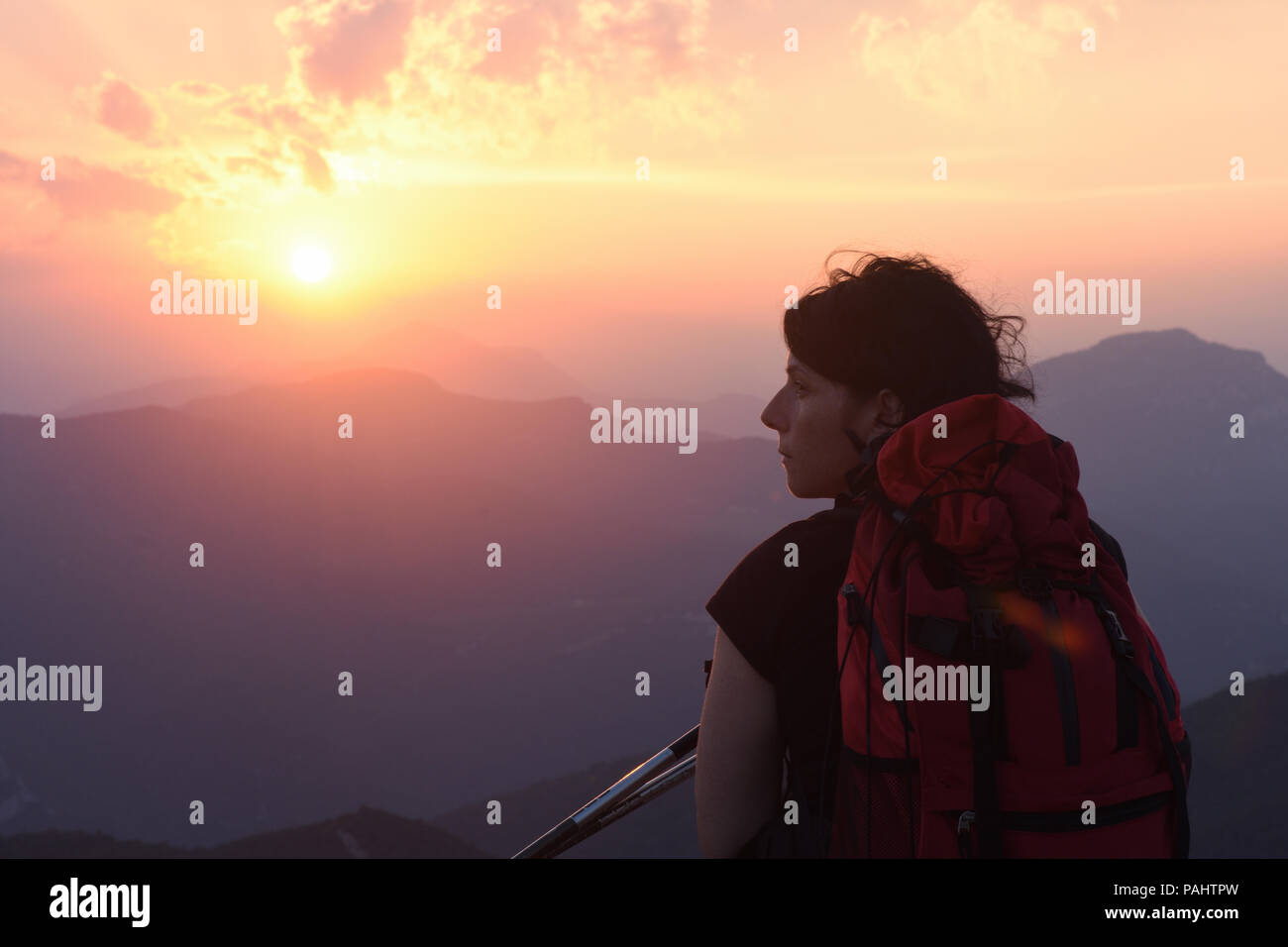 female hiker resting and watching the sunset Stock Photo - Alamy