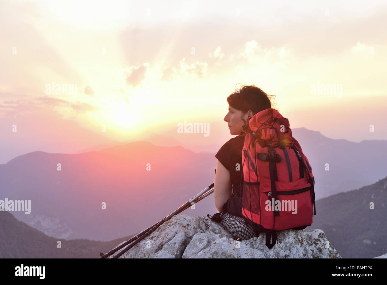 female hiker resting and watching the sunset Stock Photo - Alamy