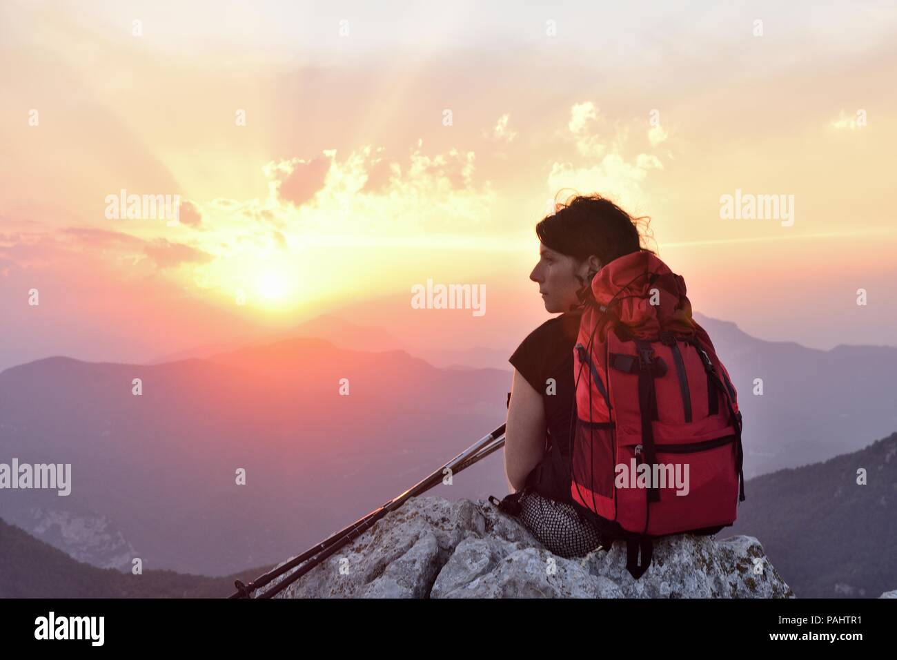 female hiker resting and watching the sunset Stock Photo - Alamy