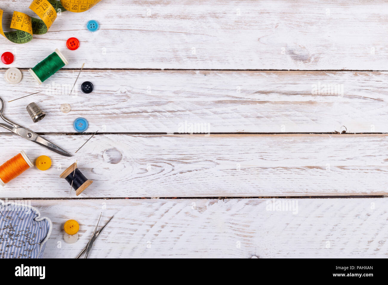 Beautiful set of scattered across white wooden table metal scissors ...