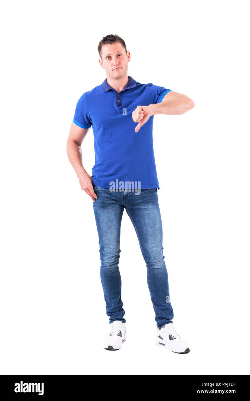 Unsure confused adult man in blue polo shirt showing thumbs down and ...