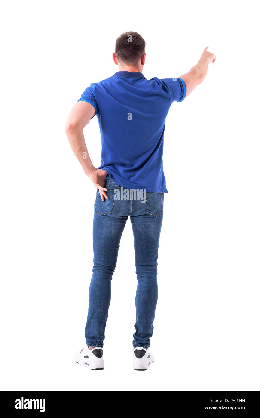 Back view of young casual adult man pointing finger showing way or ...