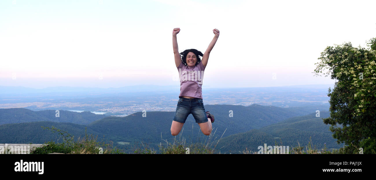 happy woman who jumps when she has reached the top Stock Photo - Alamy