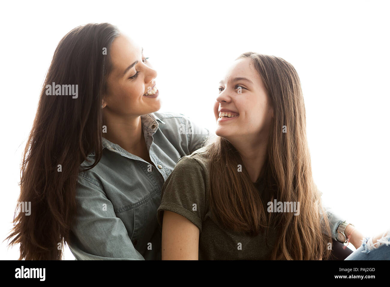 Portrait of two sisters next to a big bright window. Happy family Stock ...