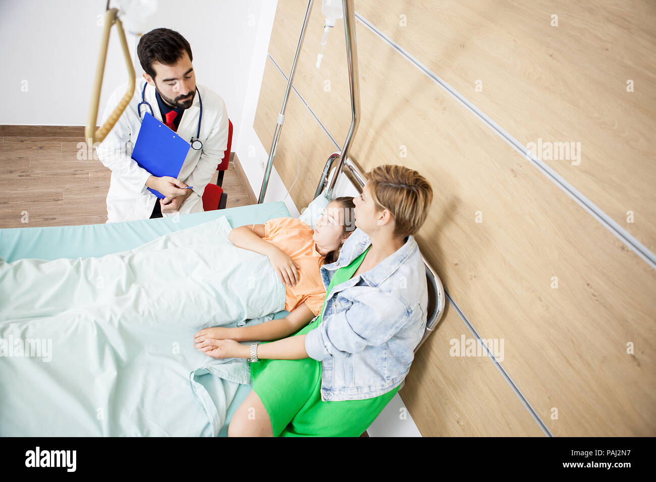 Doctor giving the news to patient girl and mother in hospital Stock ...