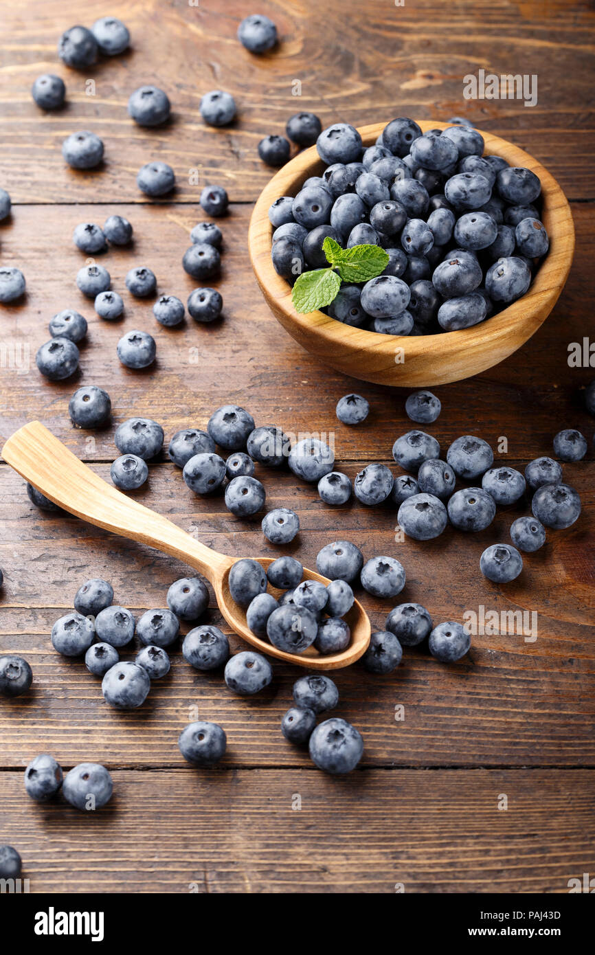 blueberries on a wooden background, berries are scattered on the table ...