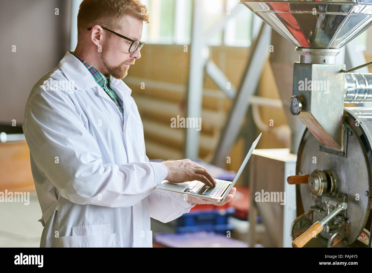 Worker Using Laptop at Factory Stock Photo - Alamy